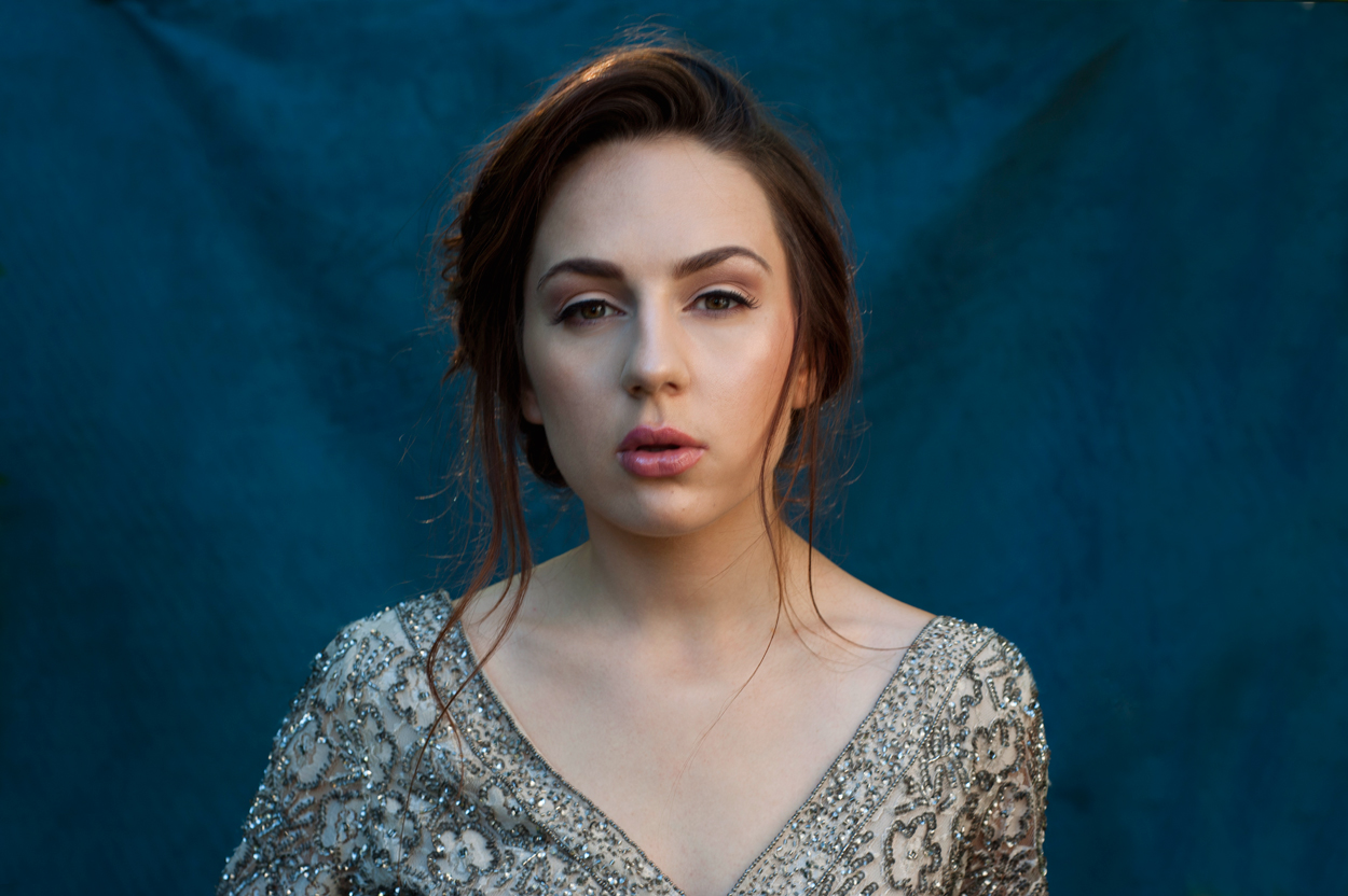 luminous portrait against blue backdrop – Baltimore Portrait Photography